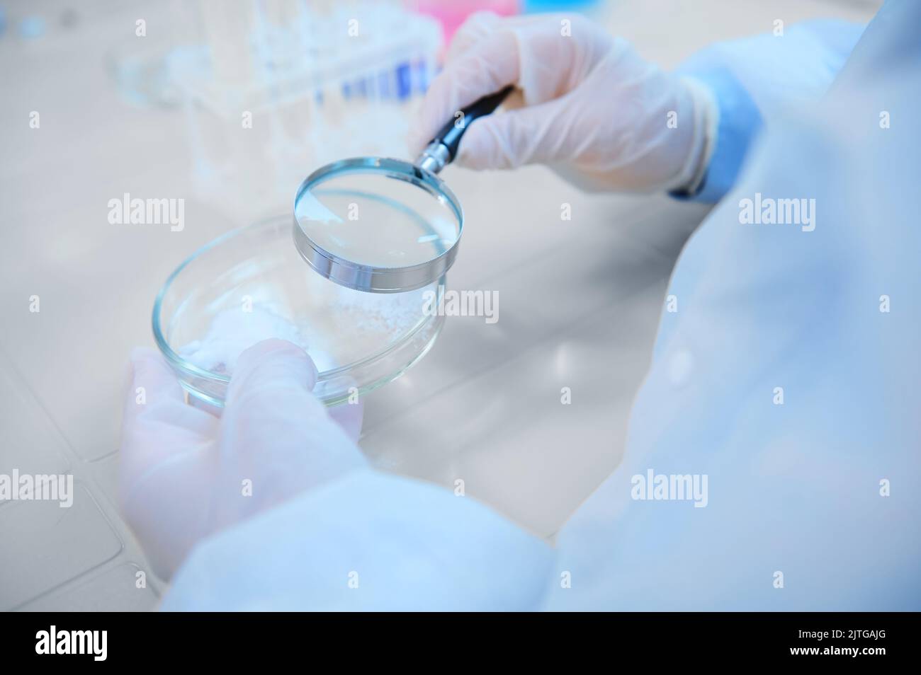 Close-up. Loupe, magnifying glass in a scientist pharmacologist hands ...