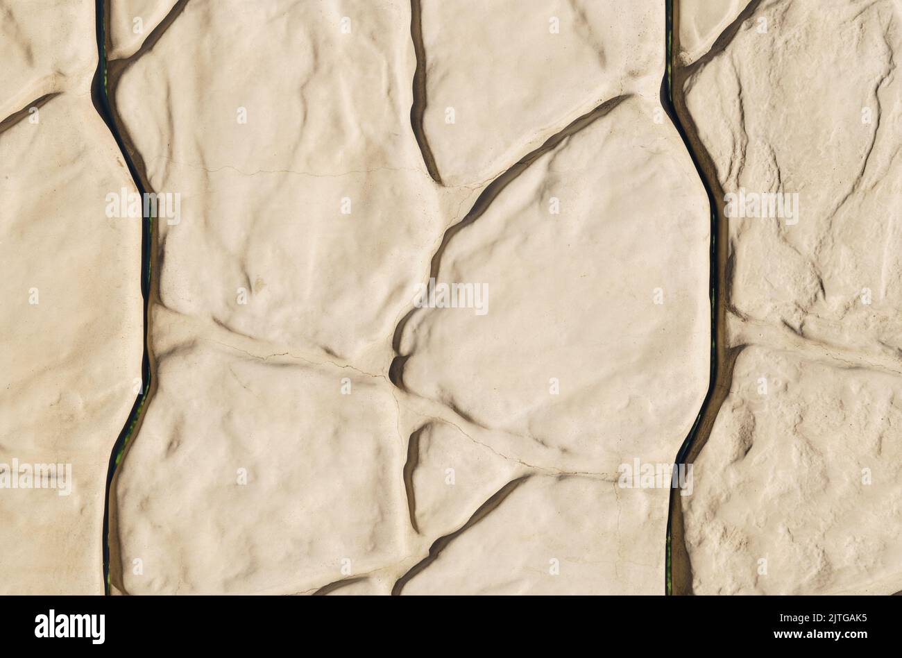 Background wall texture with large stone tiles in light colors ...