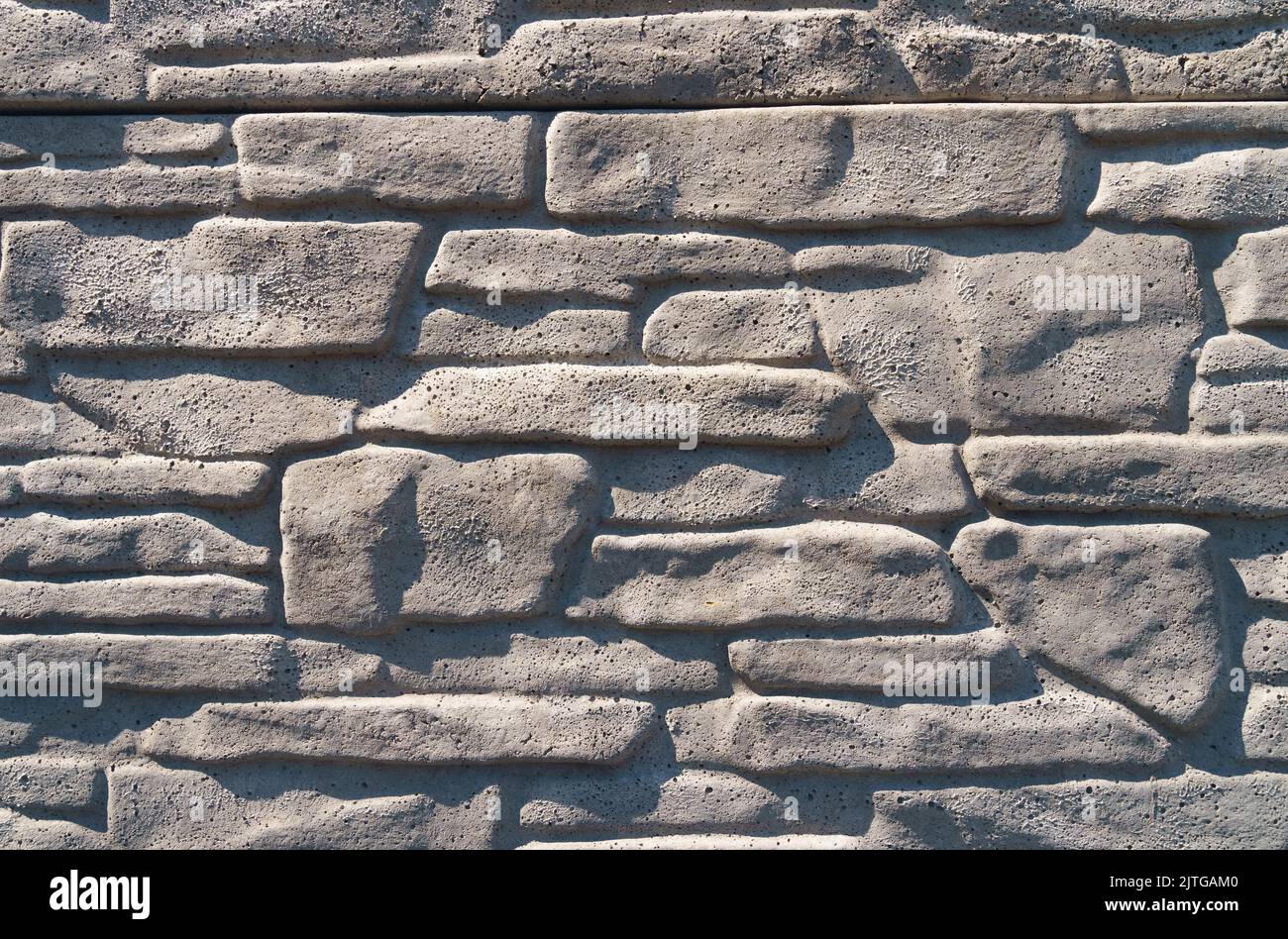 Background wall texture with large stone tiles in dark gray color ...
