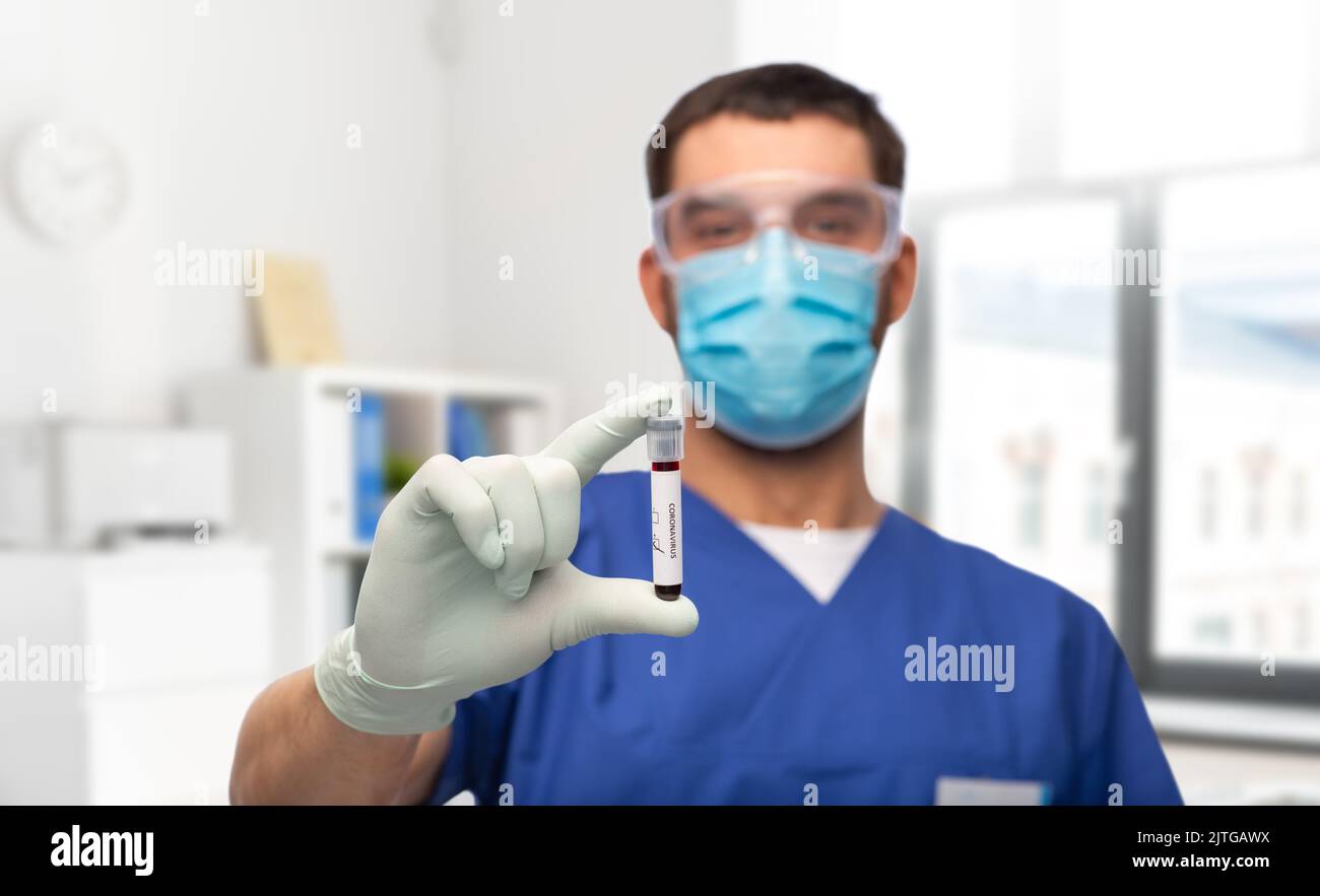 male doctor in mask with blood in test tube Stock Photo - Alamy