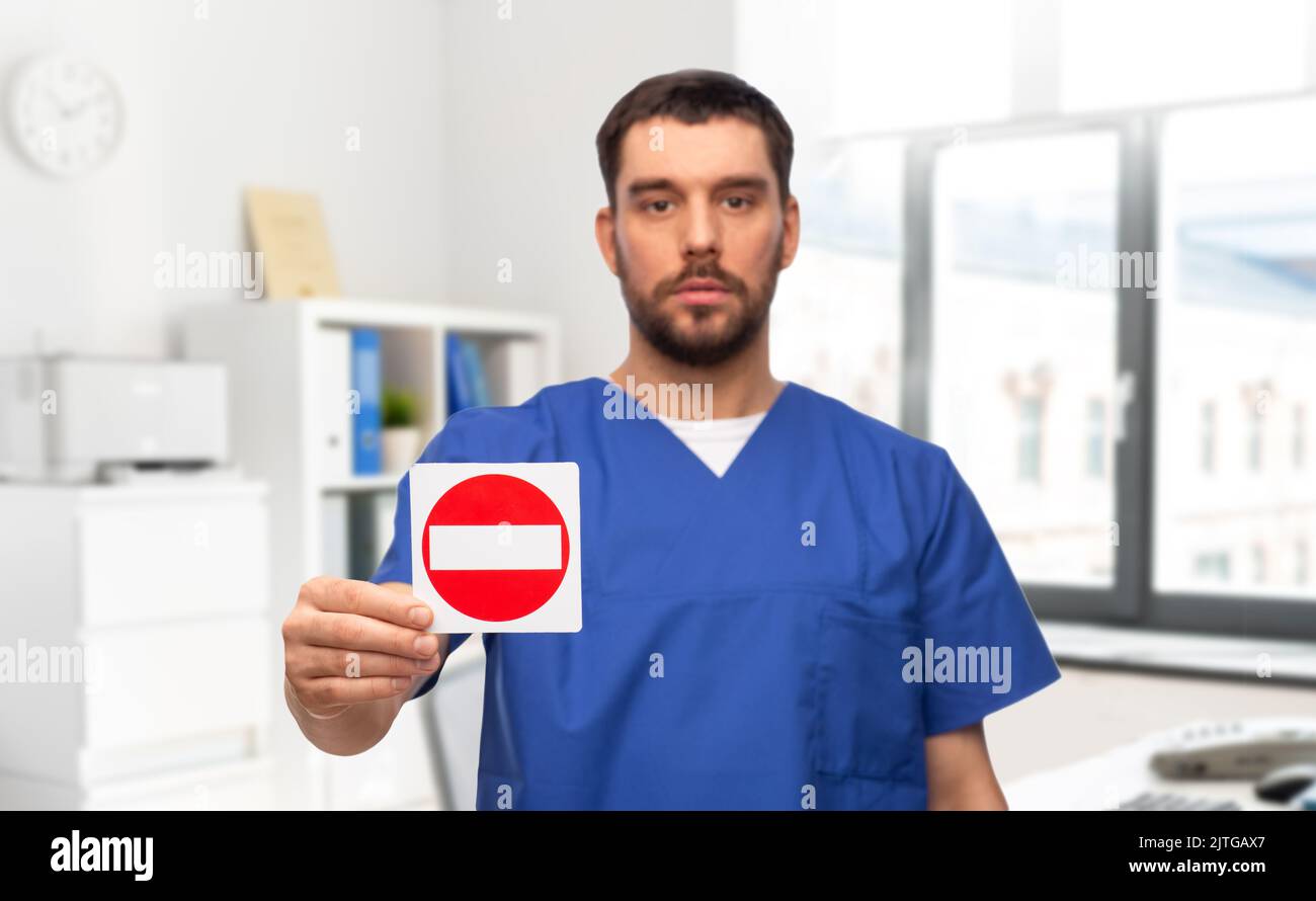doctor or male nurse showing stop sign Stock Photo - Alamy