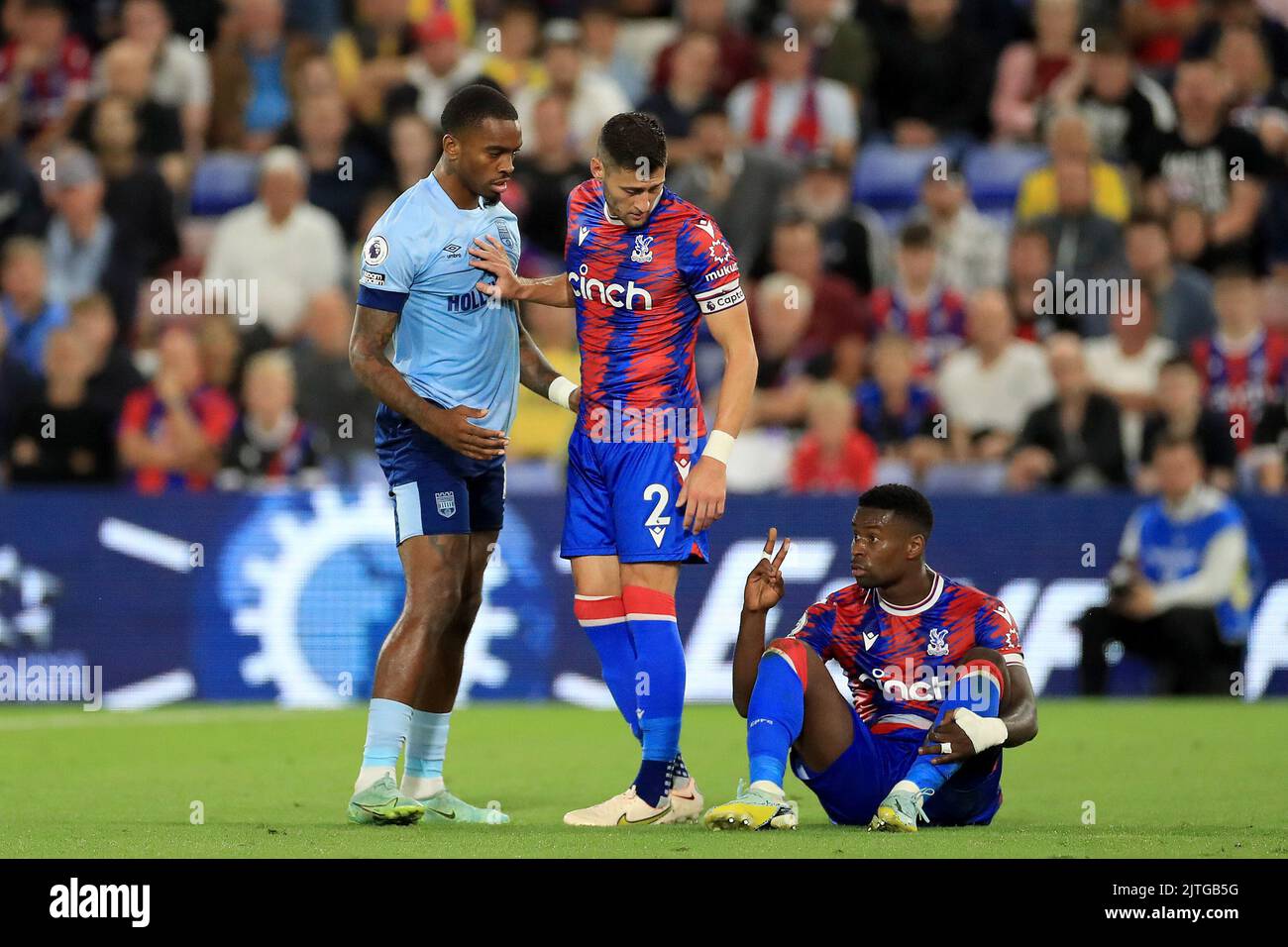 Marc Gu hi #6 of Crystal Palace signals to referee, Simon Hooper how ...