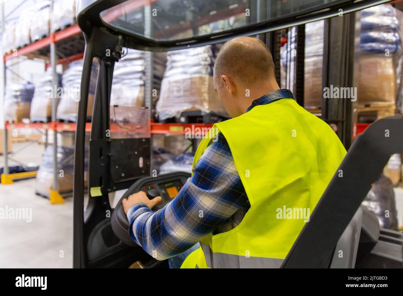 man operating forklift loader at warehouse Stock Photo - Alamy