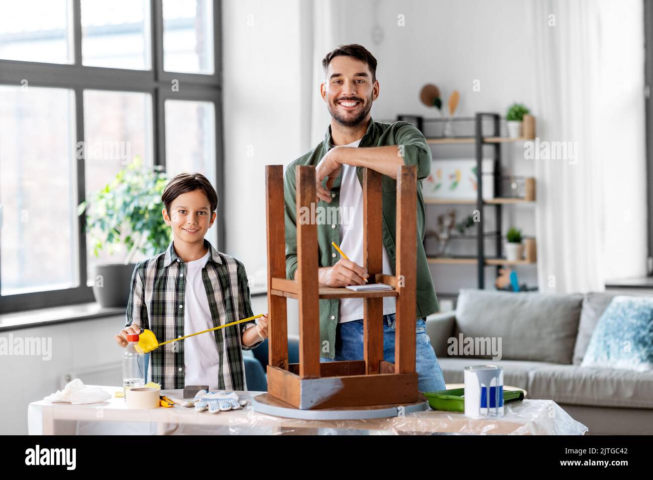 father and son with ruler measuring old table Stock Photo - Alamy