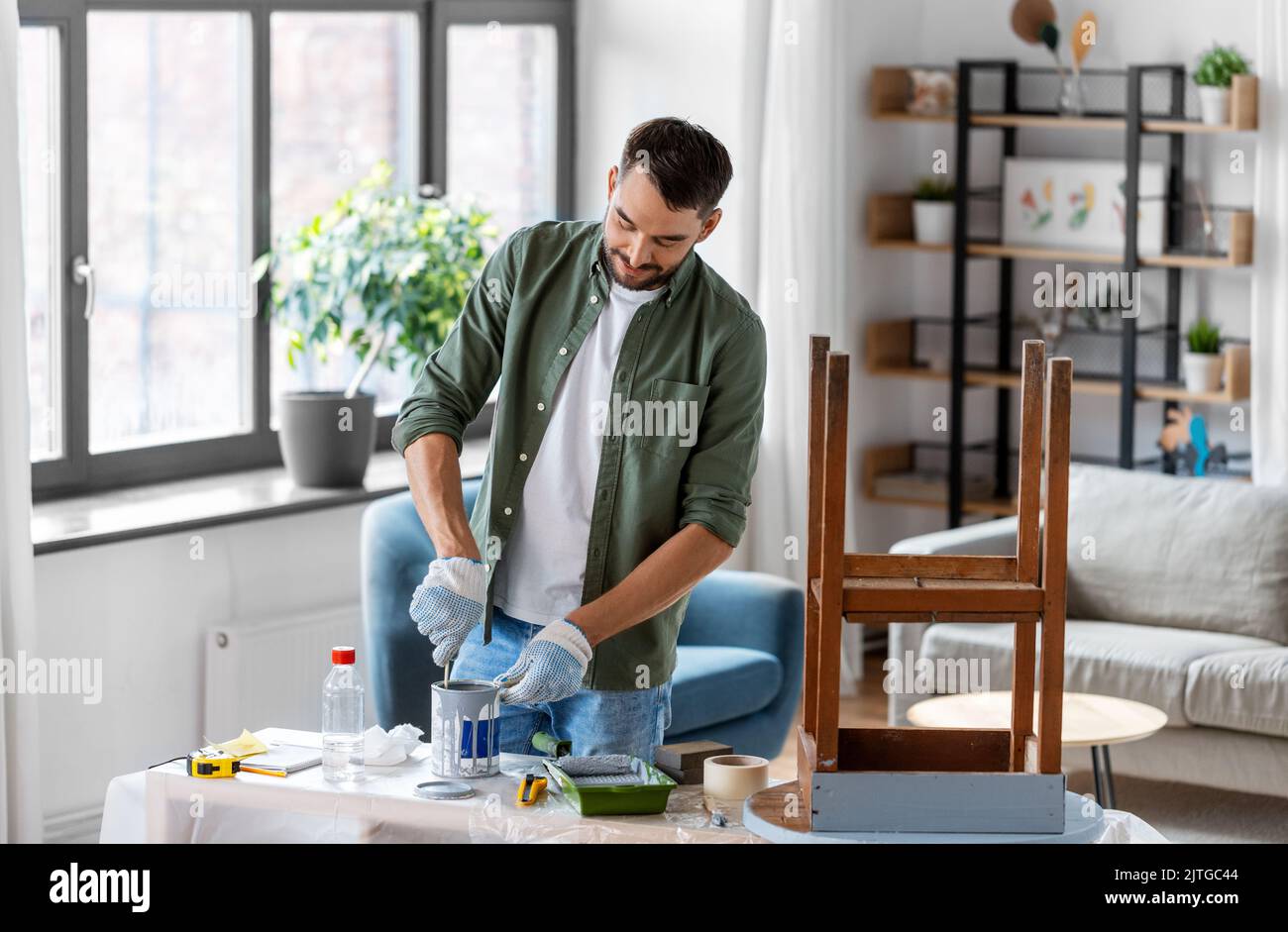 man stirring can with grey color paint at home Stock Photo - Alamy