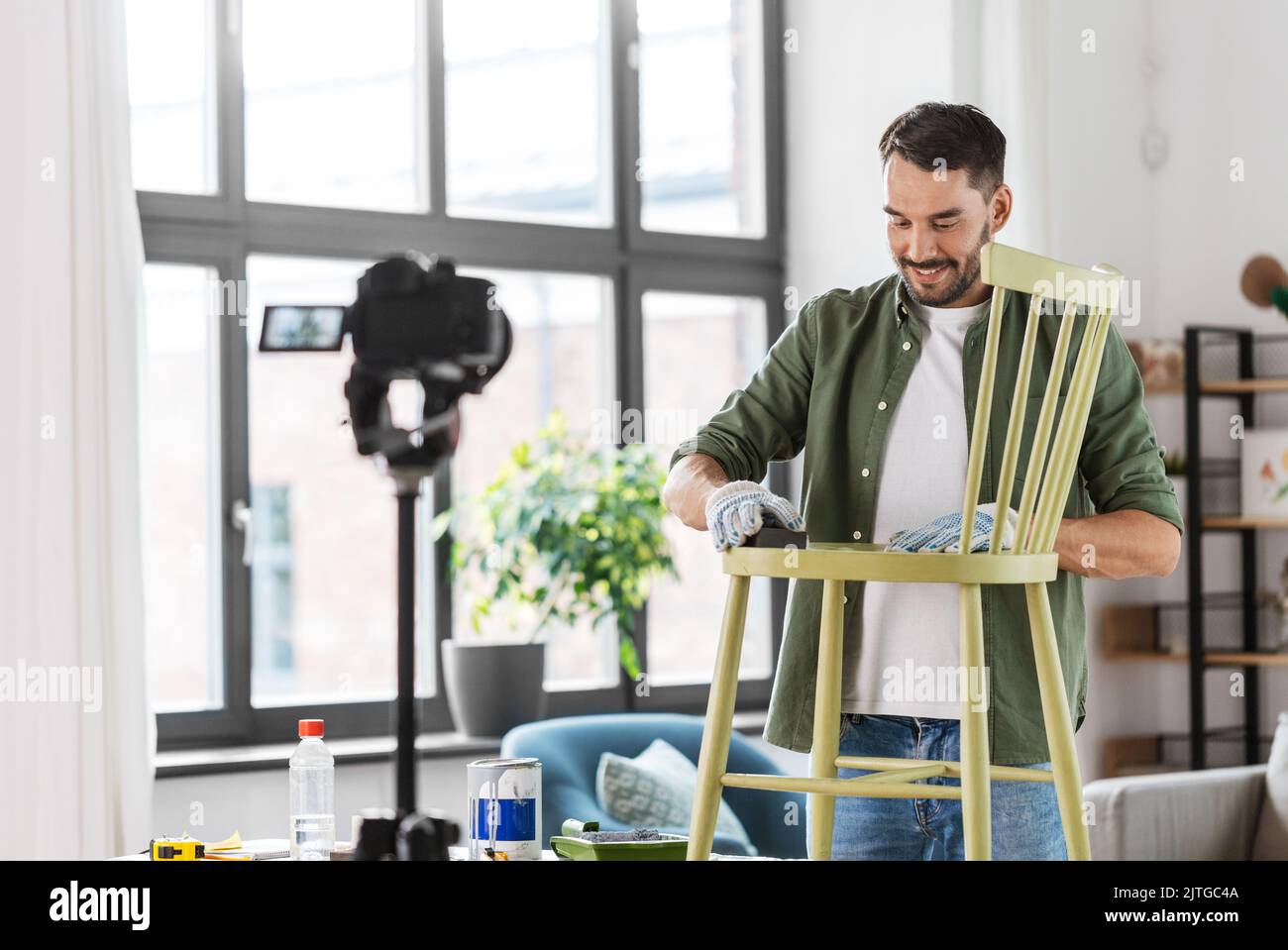 man or blogger showing old chair renovation Stock Photo - Alamy