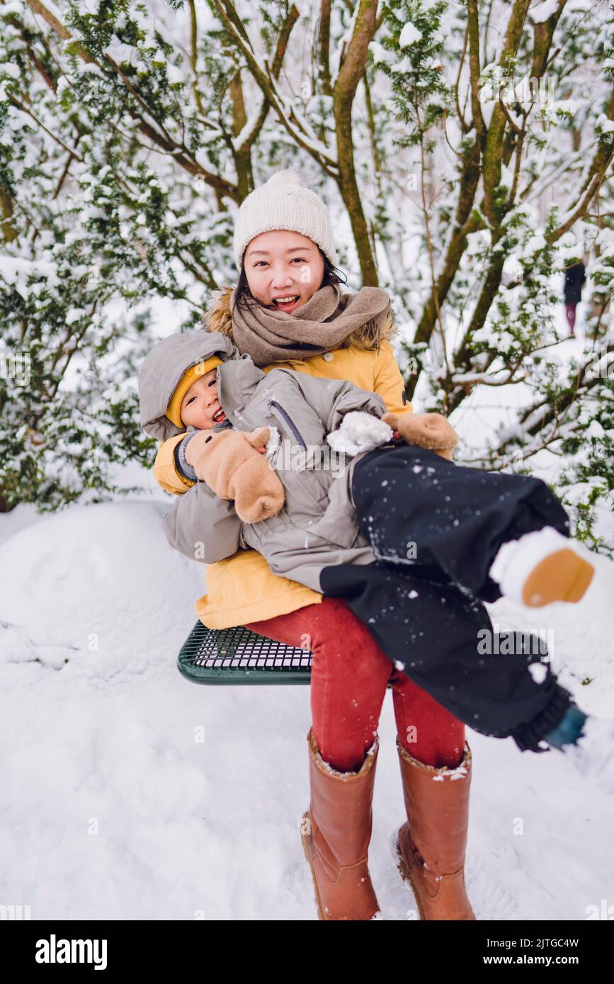 Mom and son hugging and playing in snow Stock Photo - Alamy