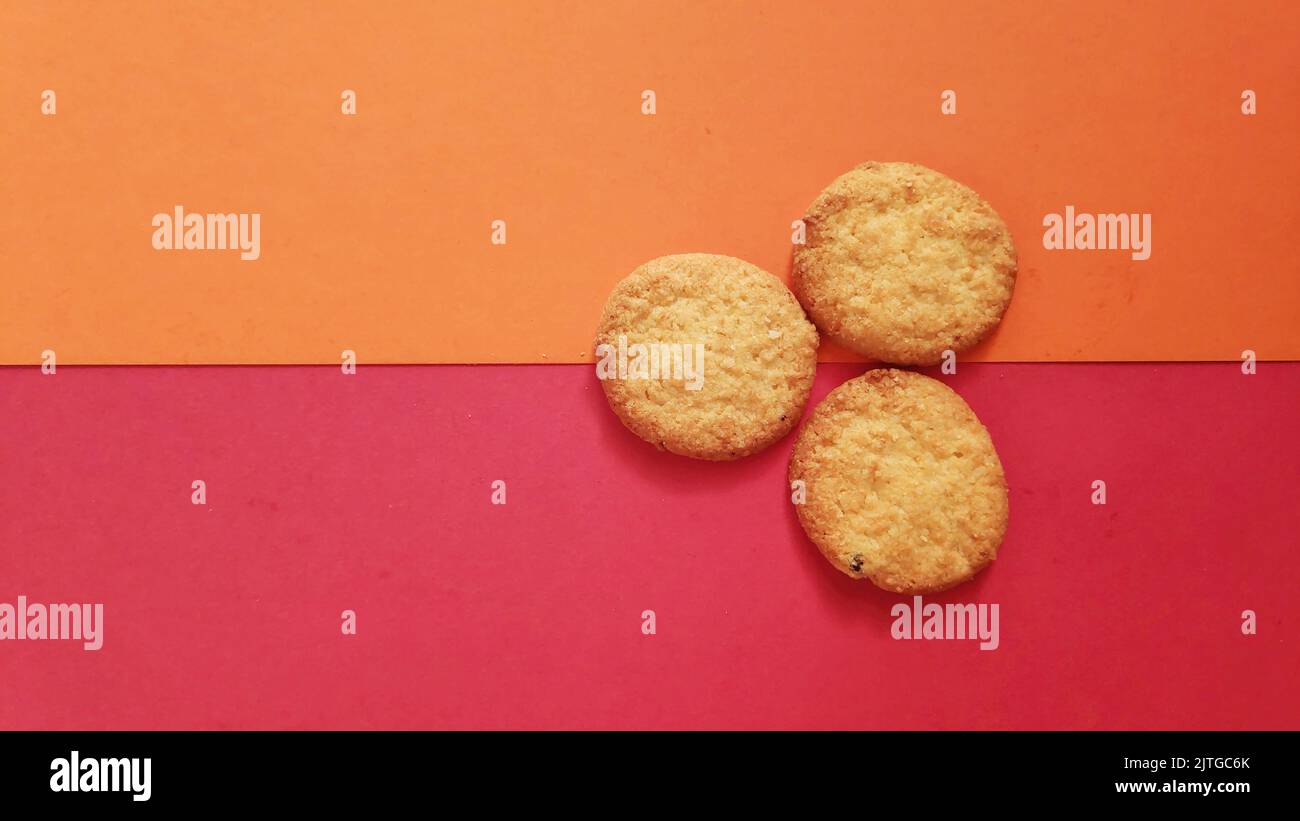 Some cookies on colorful paper background Stock Photo - Alamy