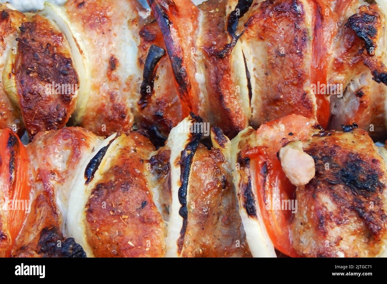 Shish kebab with onions and tomatoes close-up. High quality photo Stock ...