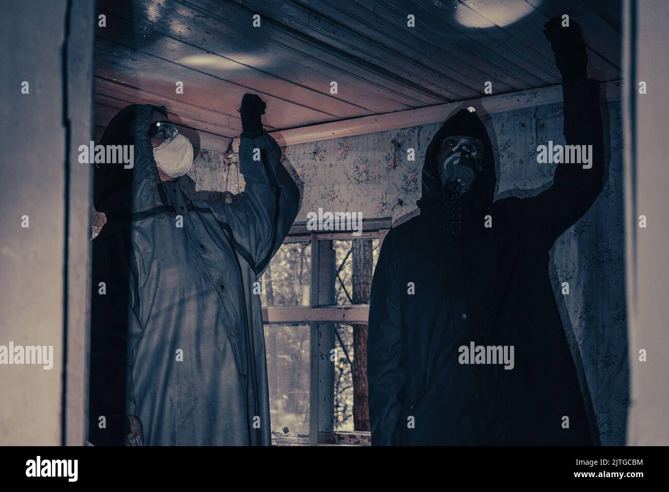 Fictional movie poster. People with flashlights, masks and protective ...