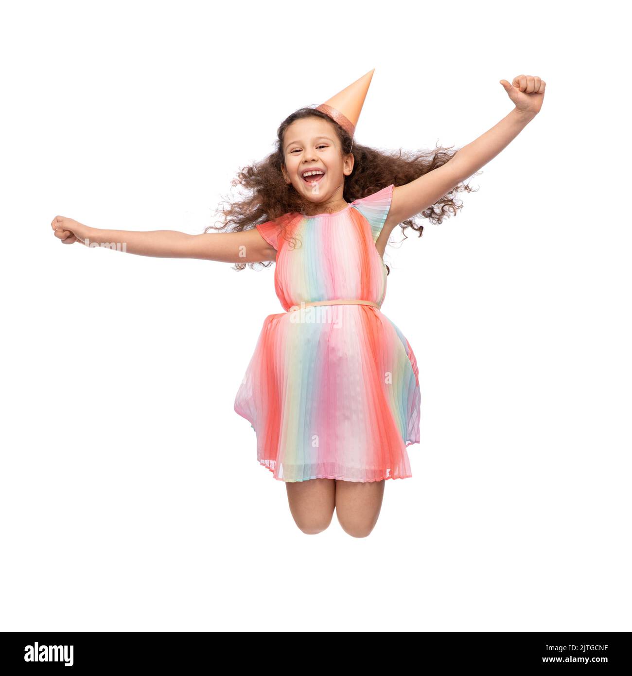 smiling little girl in birthday party hat jumping Stock Photo - Alamy