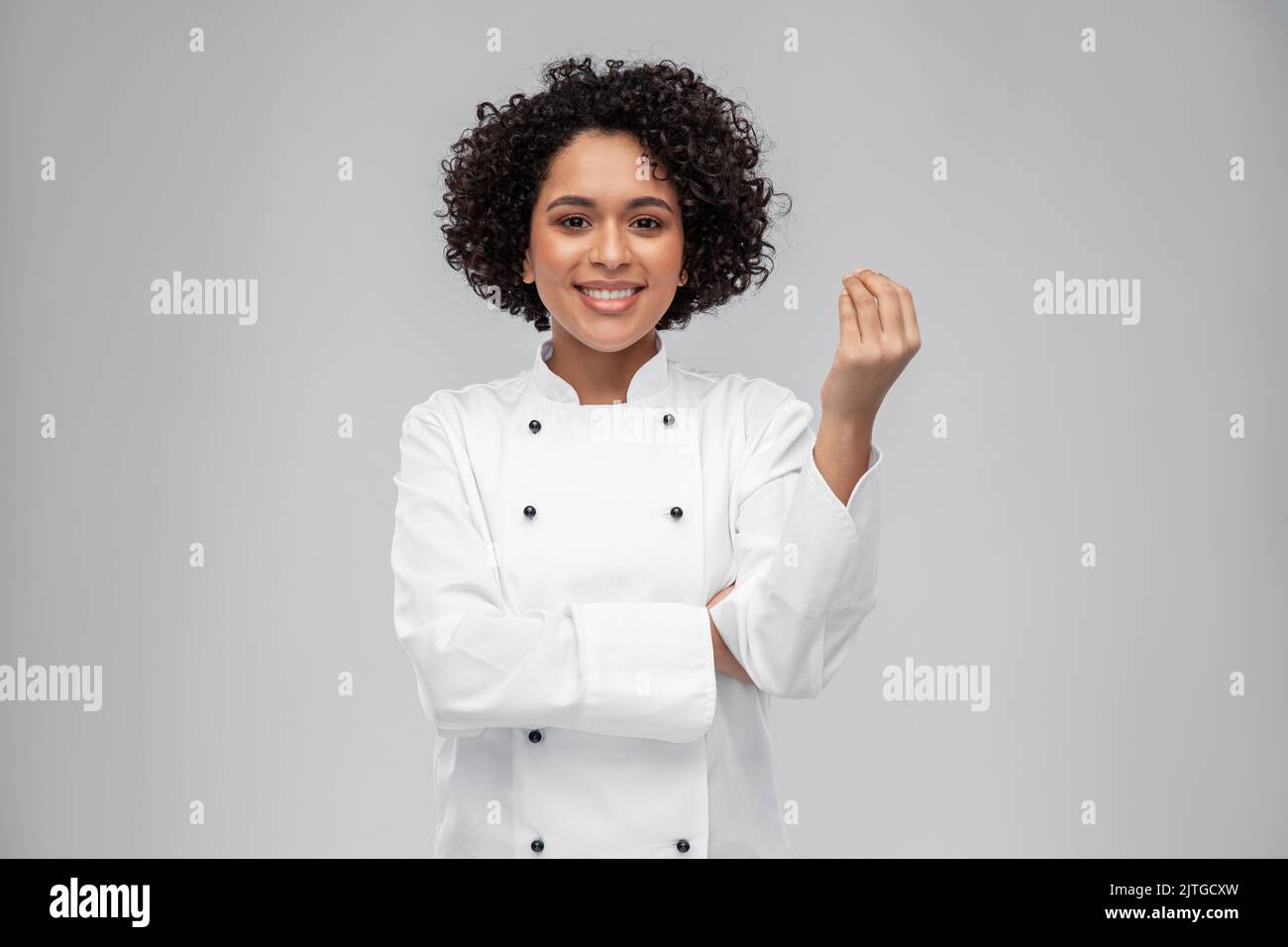happy female chef showing gourmet sign Stock Photo - Alamy