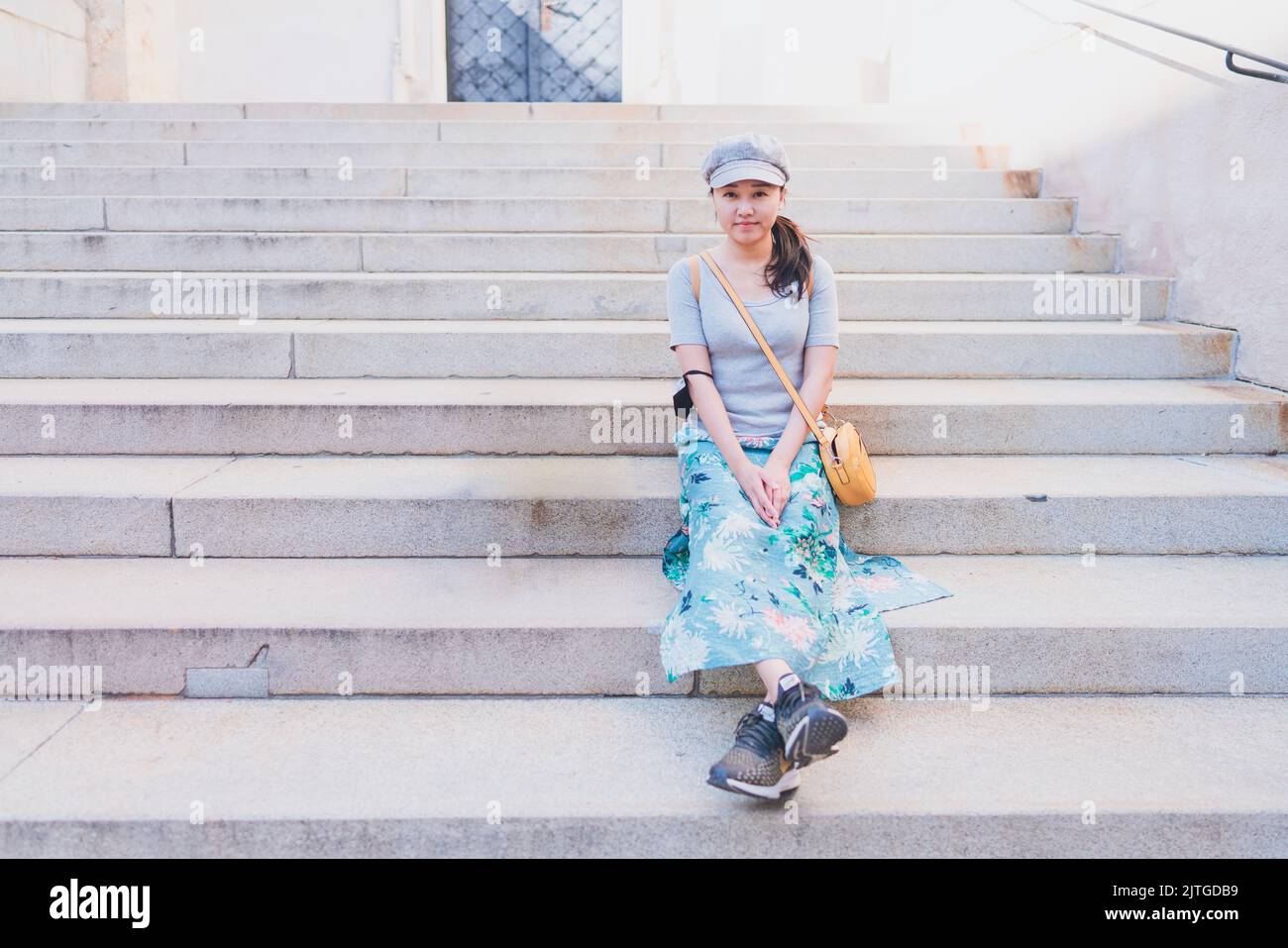 A girl with smile sitting on stairs Stock Photo - Alamy
