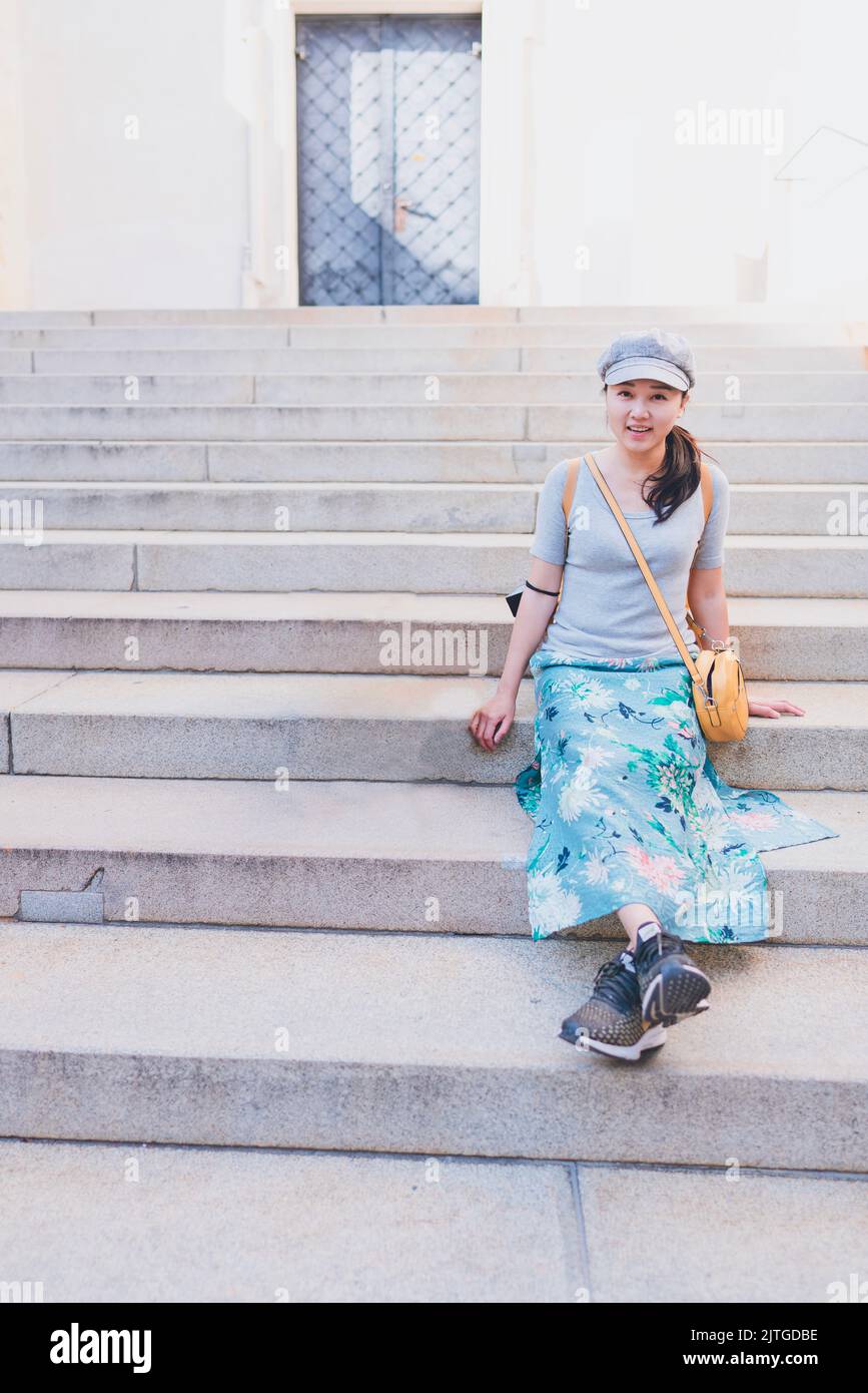 A girl with smile sitting on stairs Stock Photo - Alamy