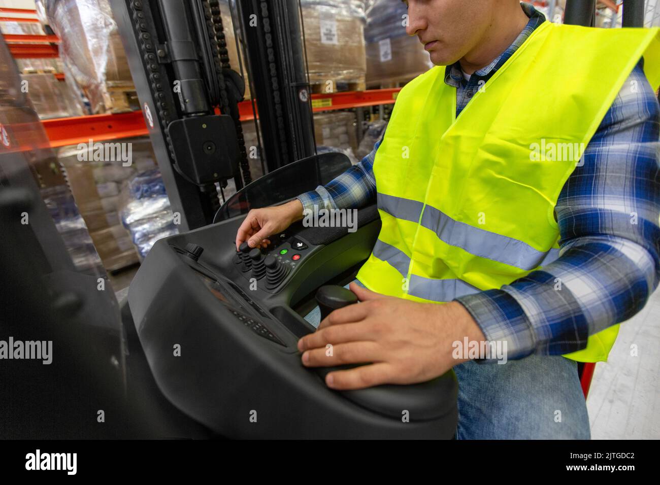 man operating forklift loader at warehouse Stock Photo - Alamy