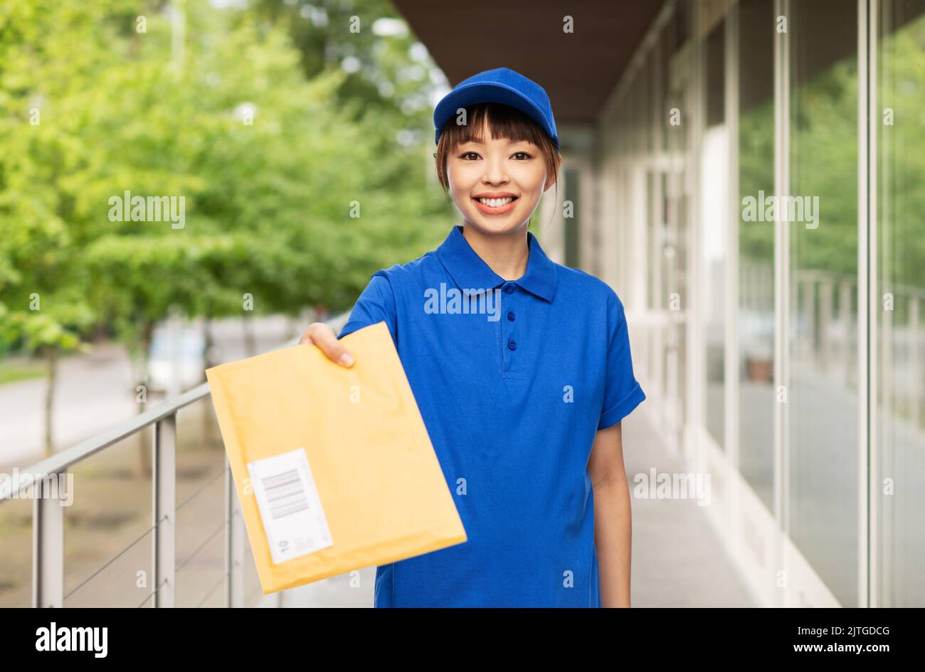 happy delivery woman holding parcel envelope Stock Photo - Alamy