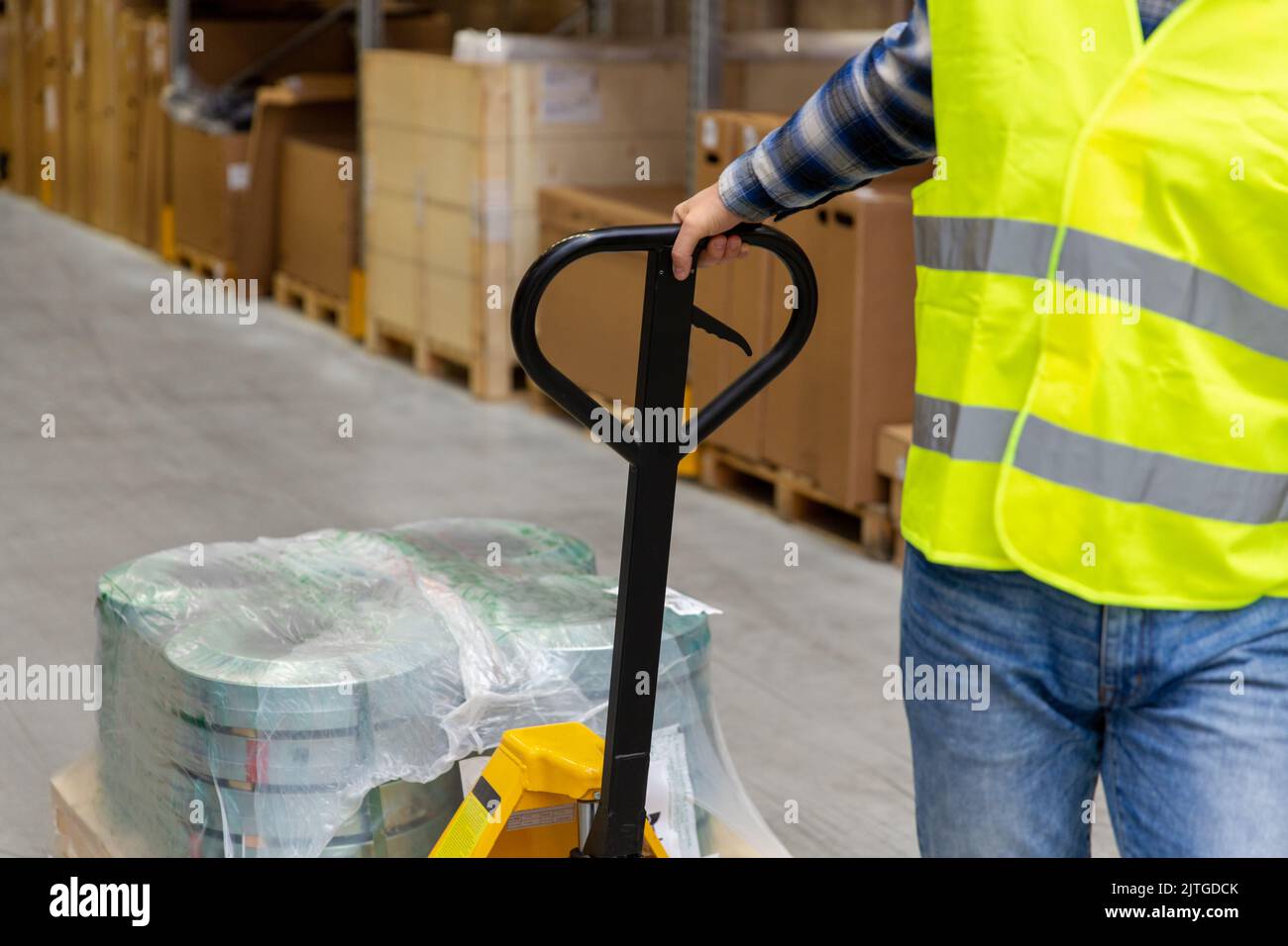 man with loader working at warehouse Stock Photo - Alamy