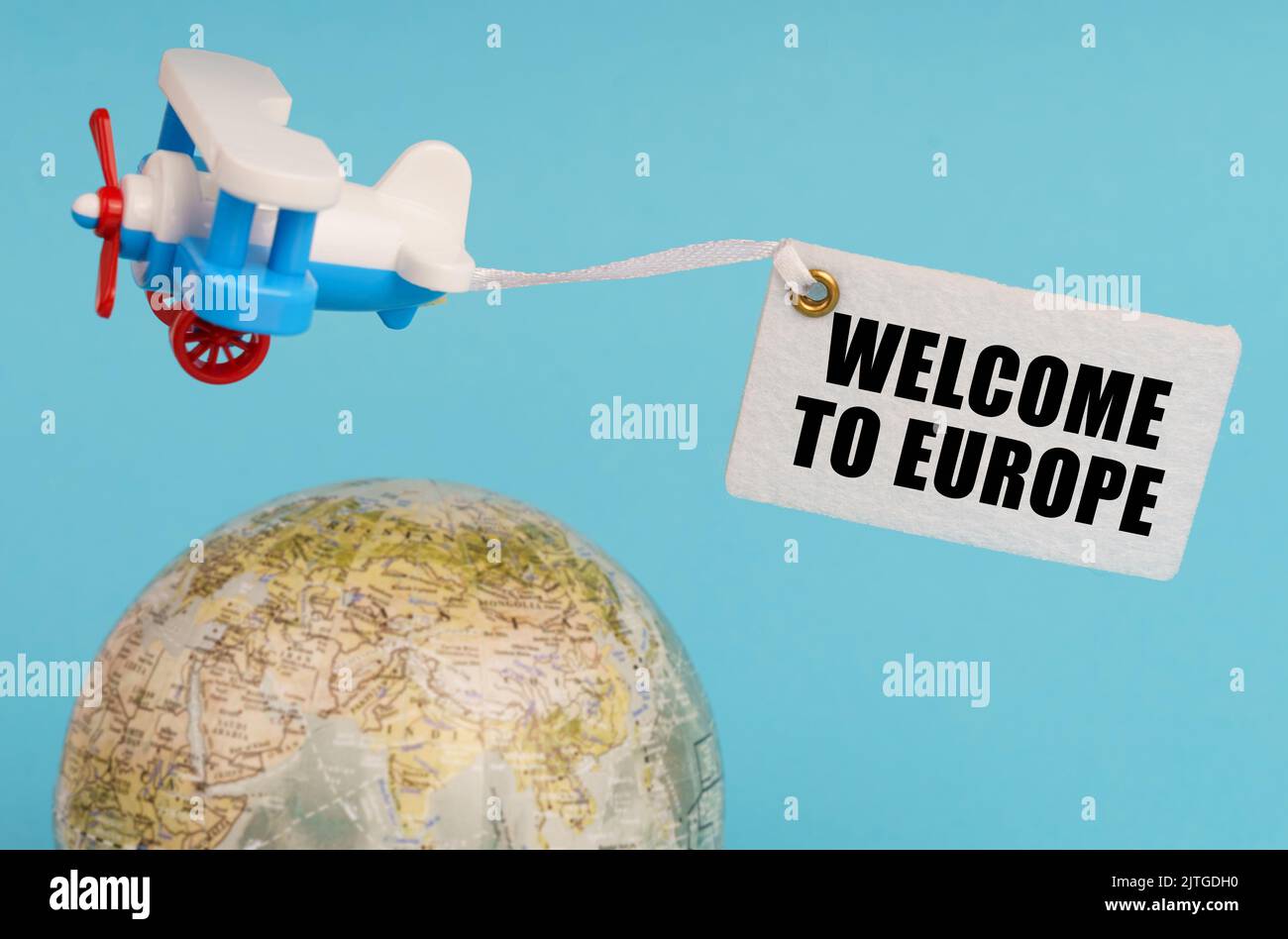 Travel and business concept. On a blue background, a globe and an ...