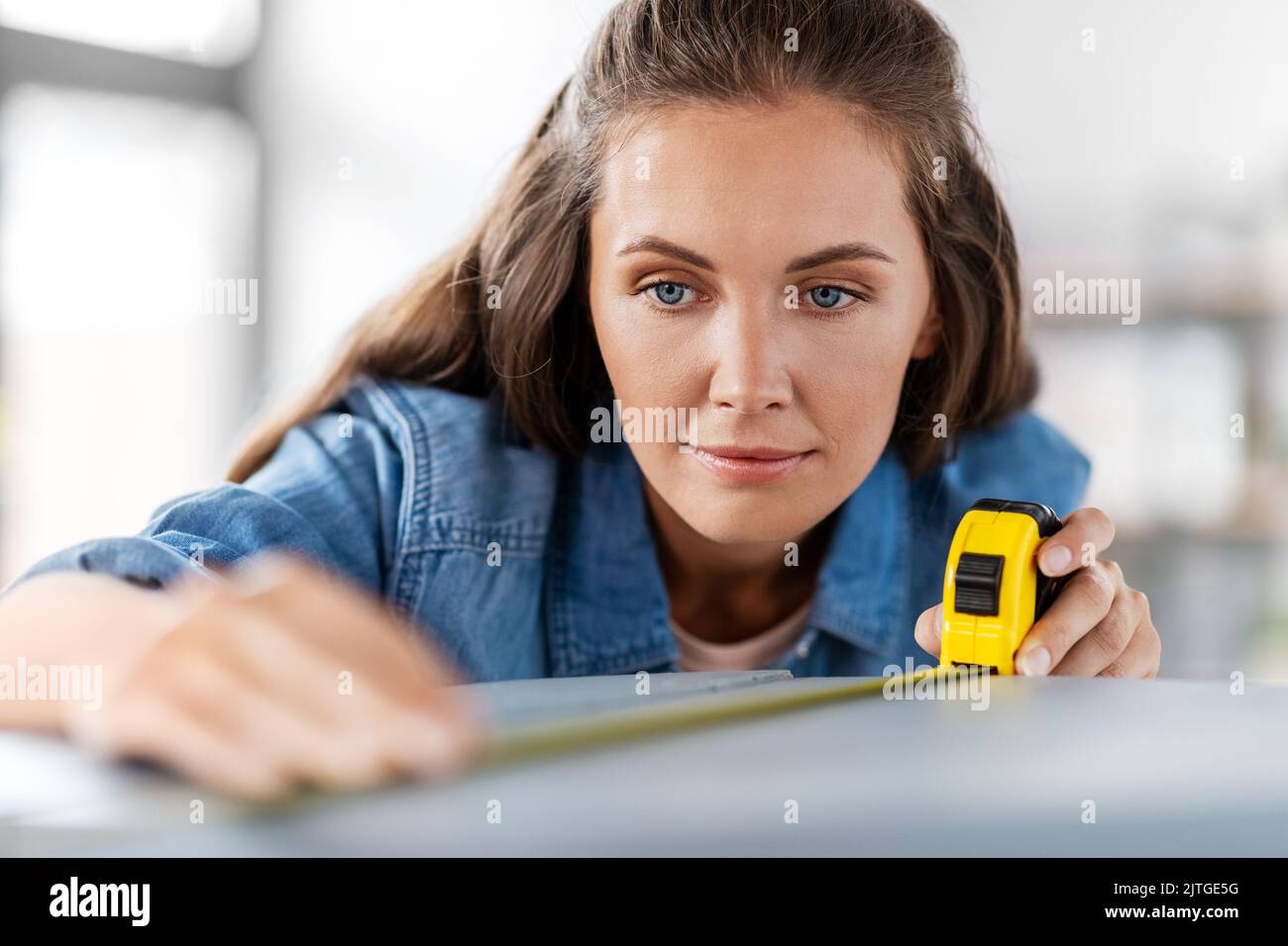 woman with ruler measuring table for renovation Stock Photo - Alamy