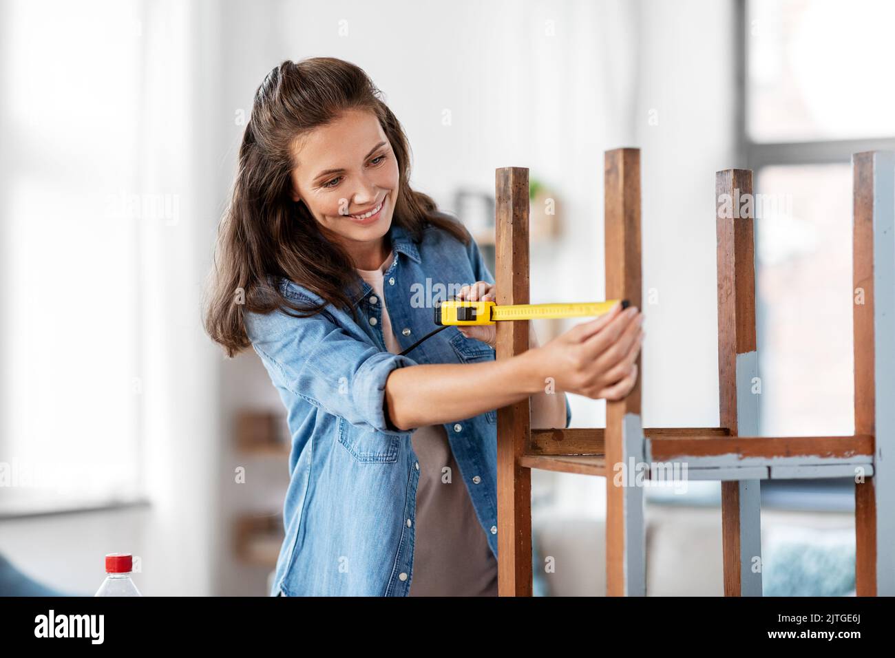 woman with ruler measuring table for renovation Stock Photo - Alamy