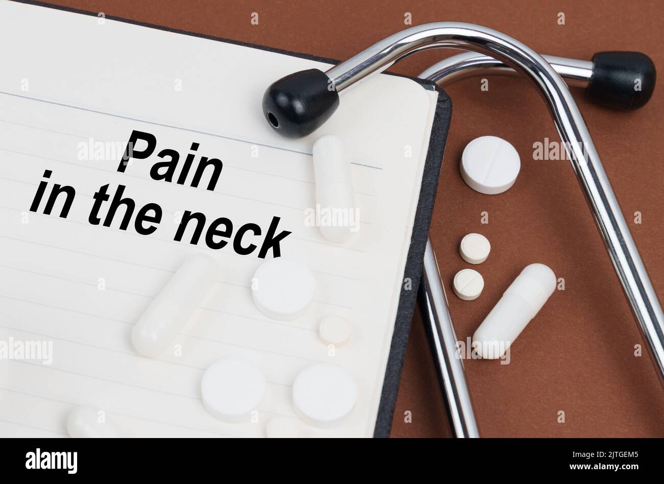 Medical concept. On a brown surface lies a stethoscope, pills and a ...