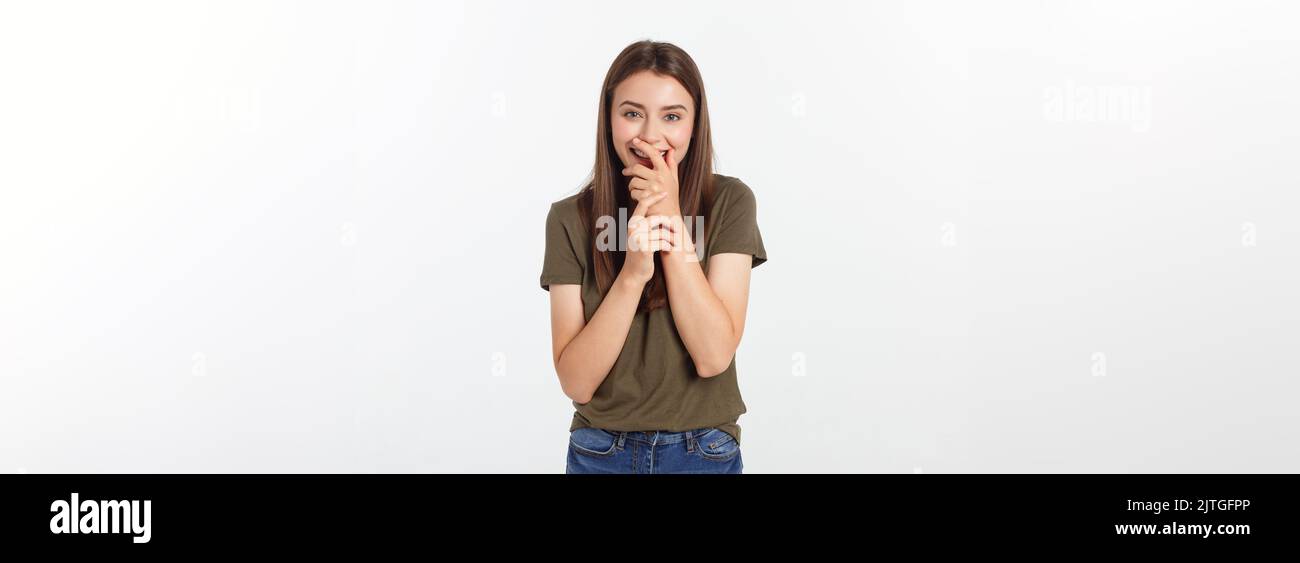 Happy woman laughing covering her mouth with a hands isolate over grey ...