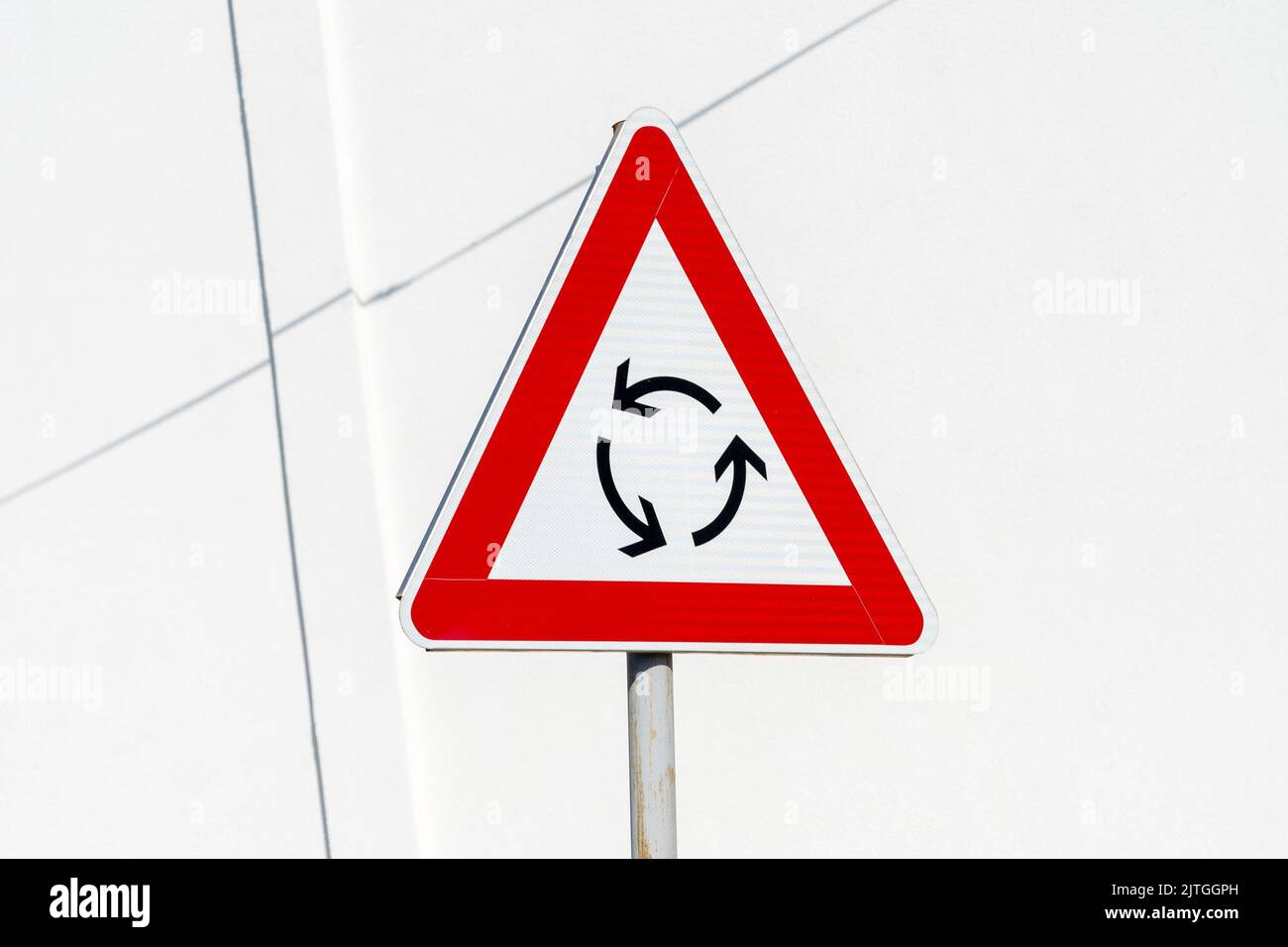 A closeup shot of a triangular roundabout sign Stock Photo - Alamy