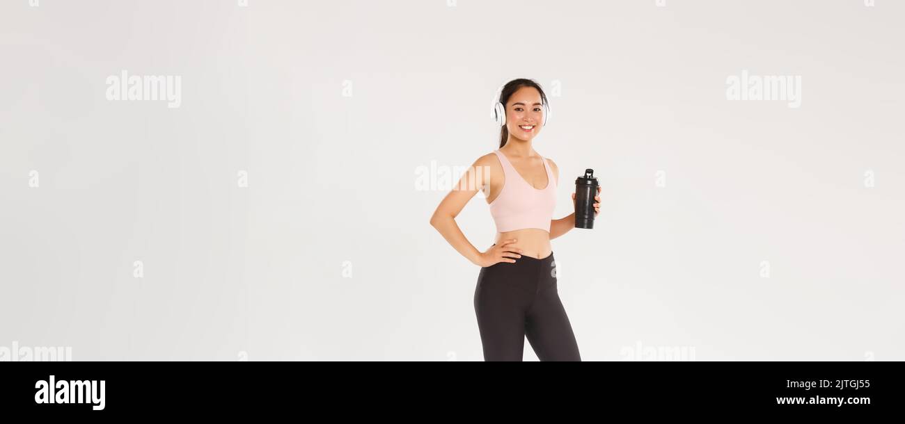 Full length of slim and healthy asian girl doing fitness, female ...