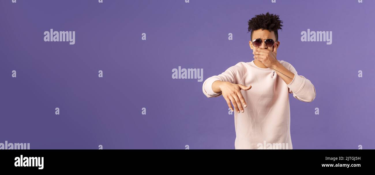 Waist-up portrait of cool and sassy, young carefree guy with dreads and ...