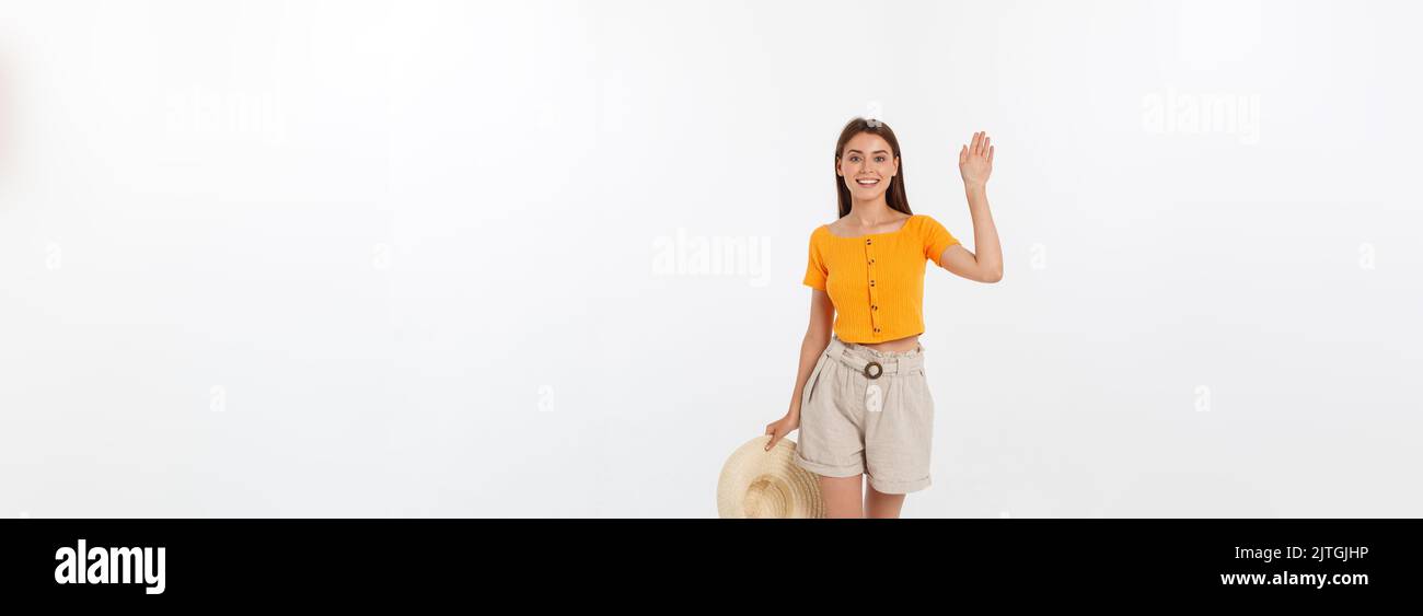 young pretty woman smiling happily and cheerfully, waving hand ...