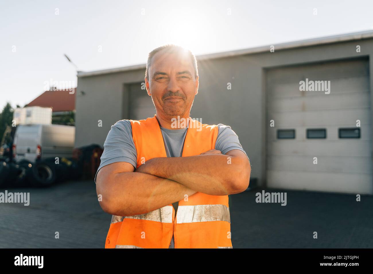 Portrait of caucasian mature man on semi-truck vehicles parking ...