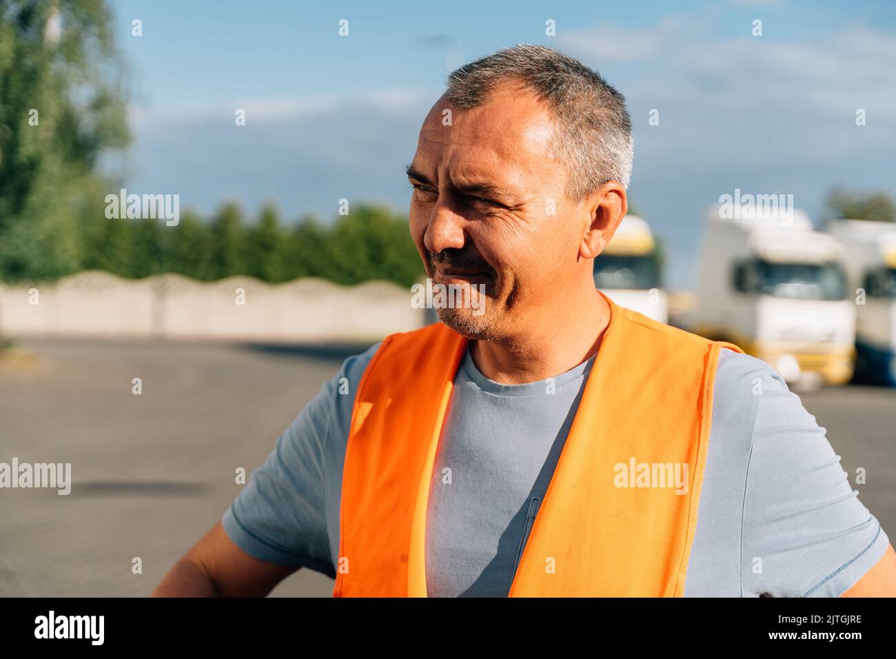 Portrait of caucasian mature man on semi-truck vehicles parking ...