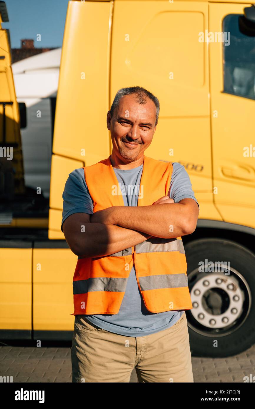 Portrait of caucasian mature man on semi-truck vehicles parking ...