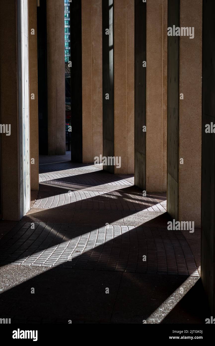 Sunlight peers though the columns of a building Stock Photo - Alamy