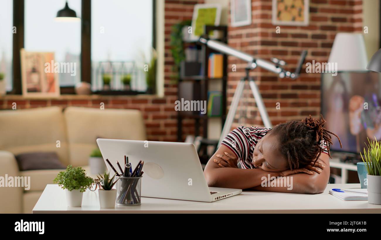 Tired stressed employee falling asleep on desk at remote work, feeling ...