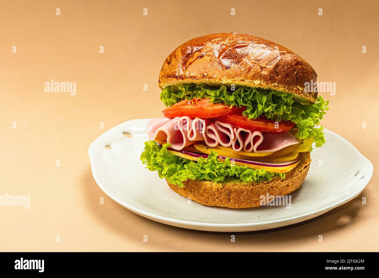 Homemade burger with ham. Fresh ingredients, ripe vegetables, fast food ...