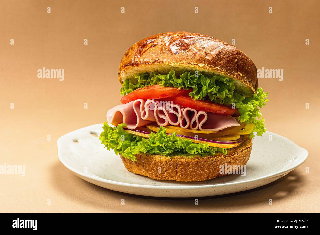 Homemade burger with ham. Fresh ingredients, ripe vegetables, fast food ...