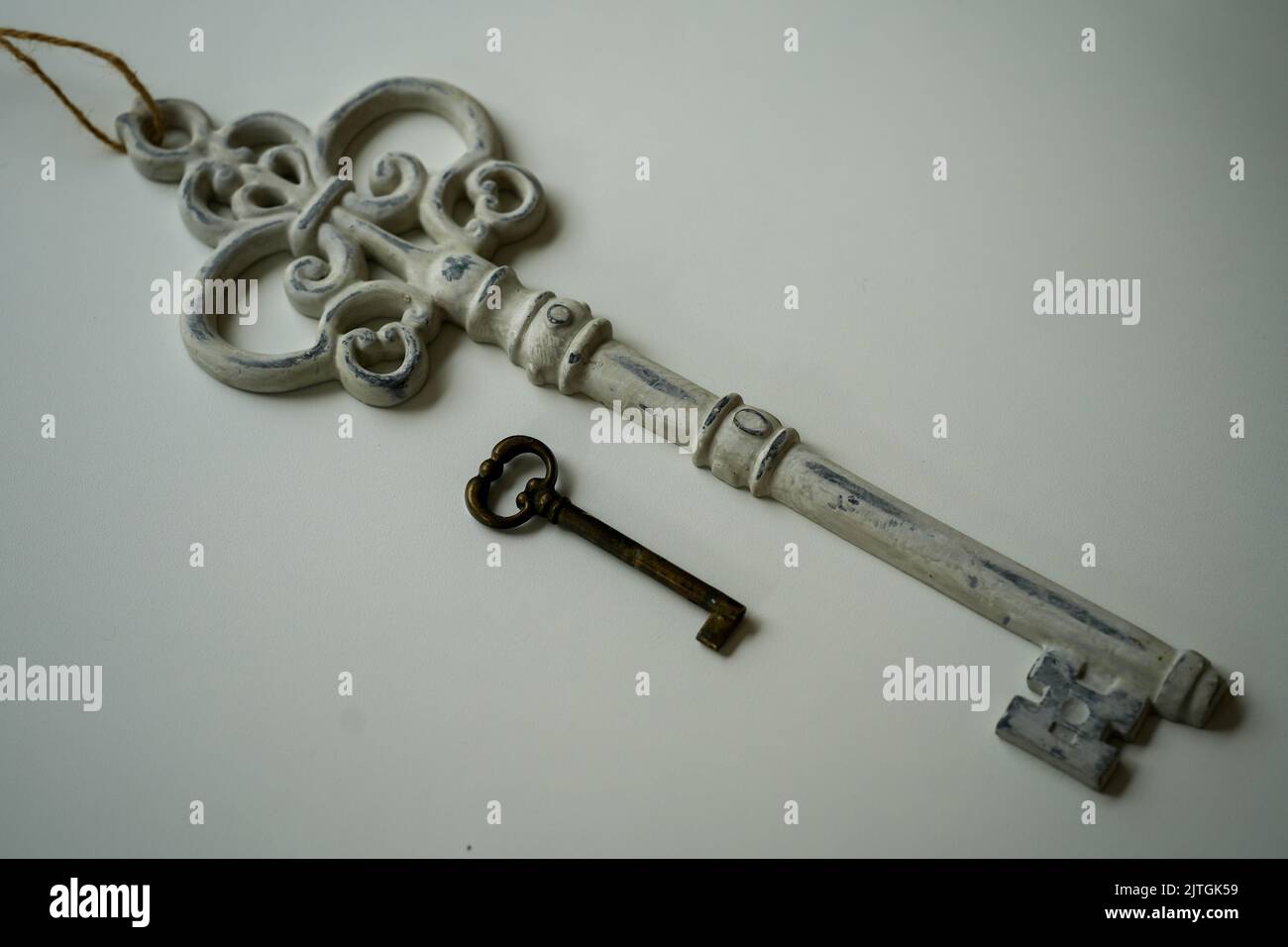 A closeup of a pair of keys on a white table Stock Photo - Alamy