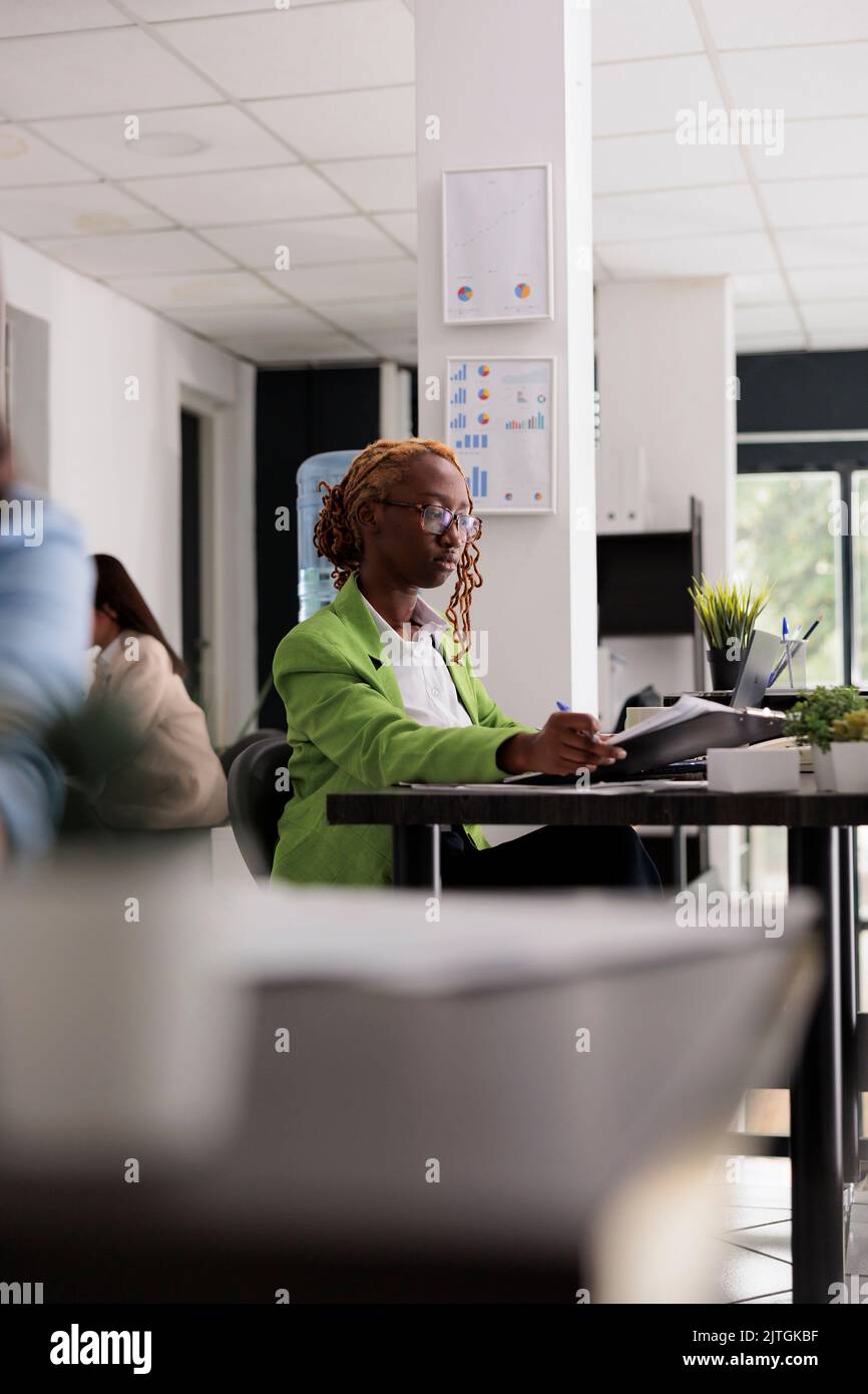 Employee working with business documents, analyzing financial report in ...