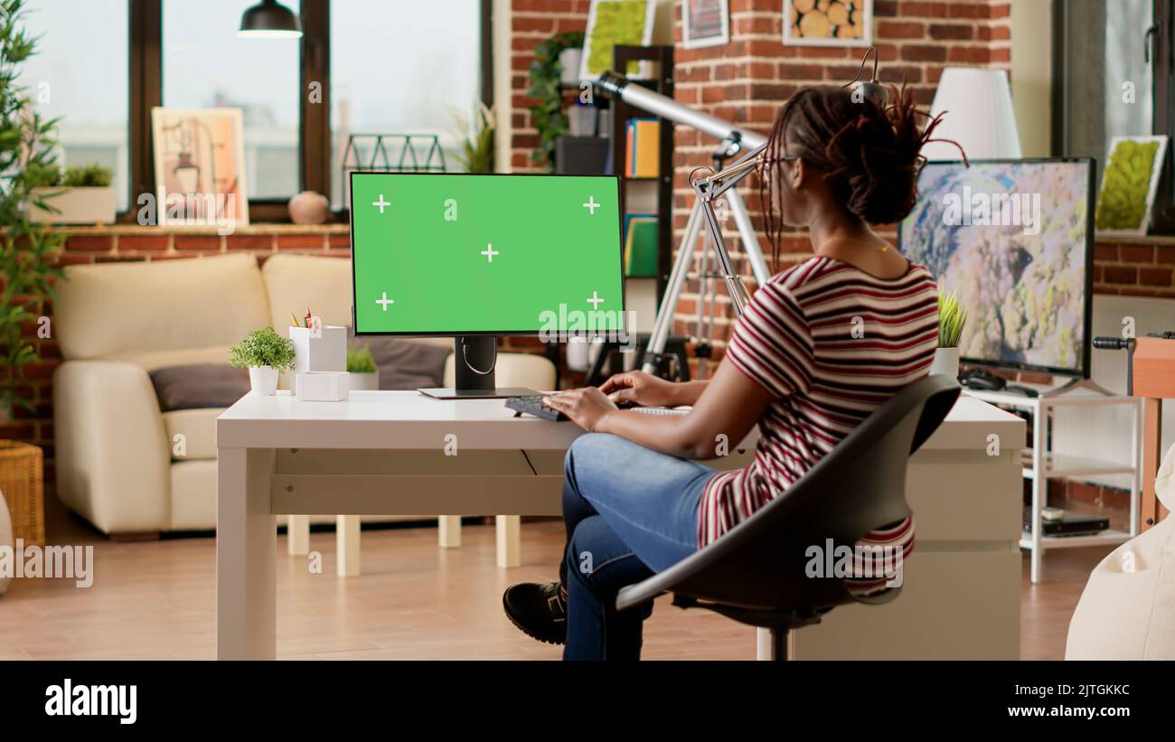 Company employee using greenscreen on computer and doing remote work ...