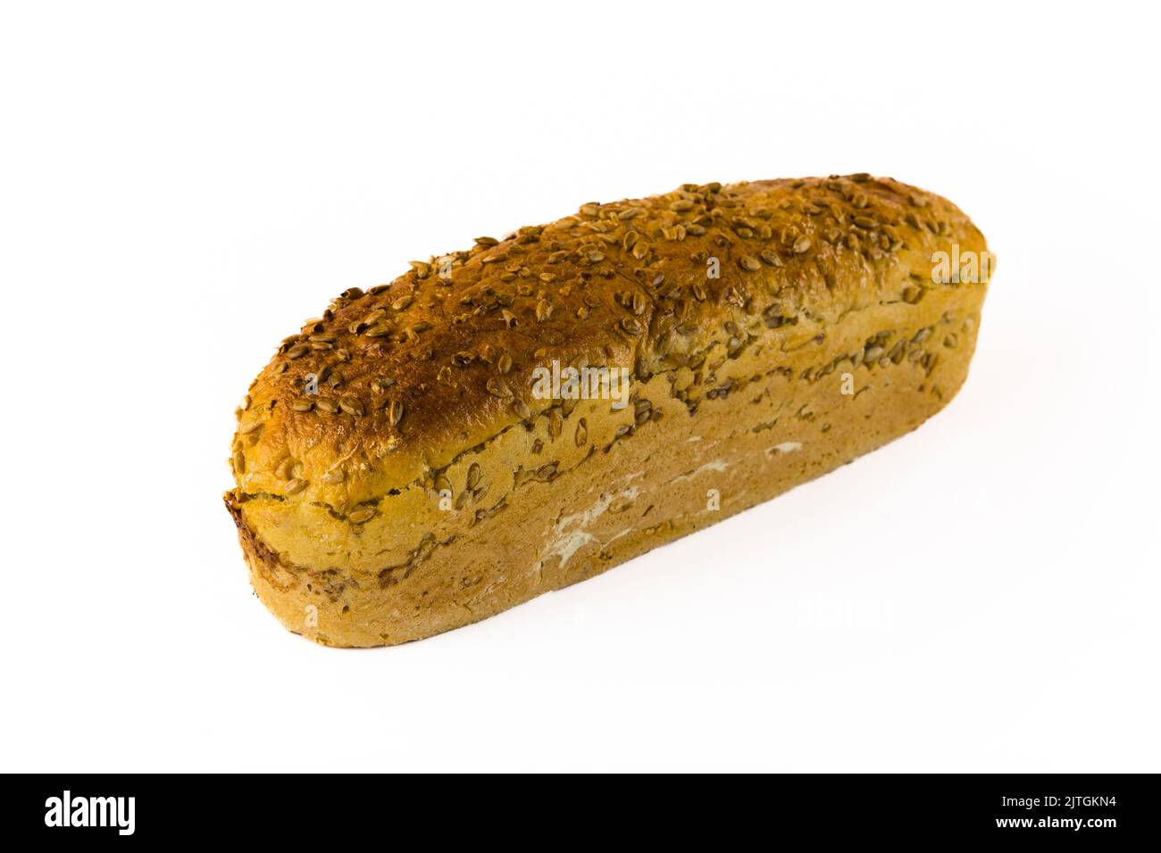 Rounded long loaf of heathy whole wheat bread with sunflower seeds ...