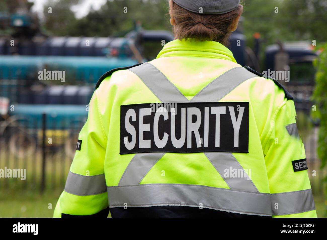 A back shot of a security guard patrolling the street next to the ...