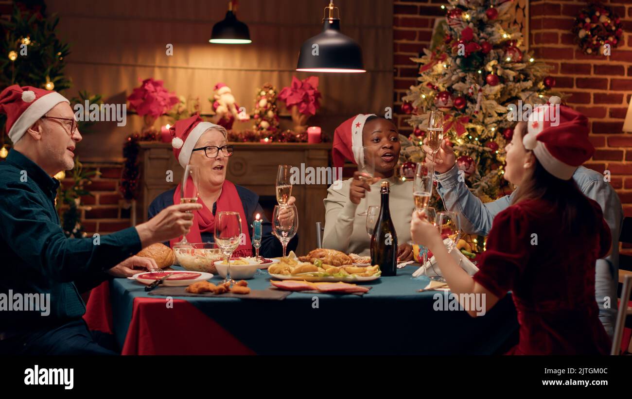 Happy family members drinking champagne while celebrating winter ...