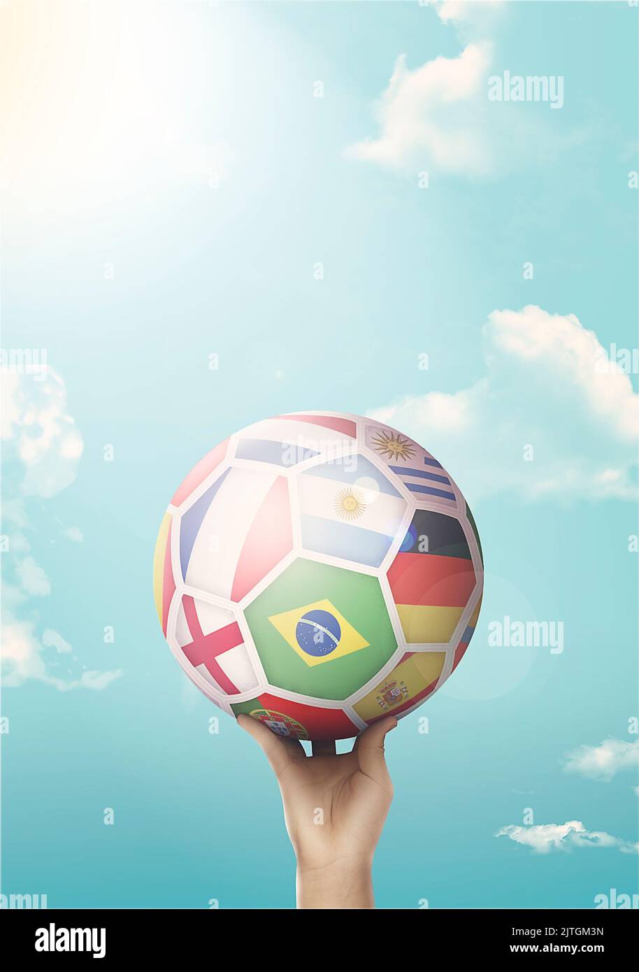 A kid holding a soccer ball with world flags against a blue sky ...