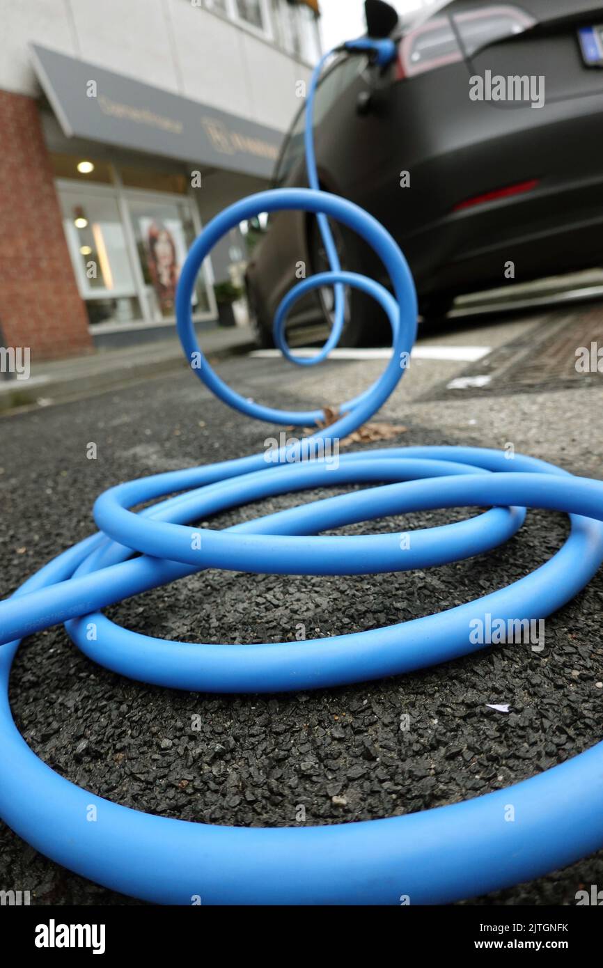Car at a charging station with blue charge cable, Germany, North Rhine ...
