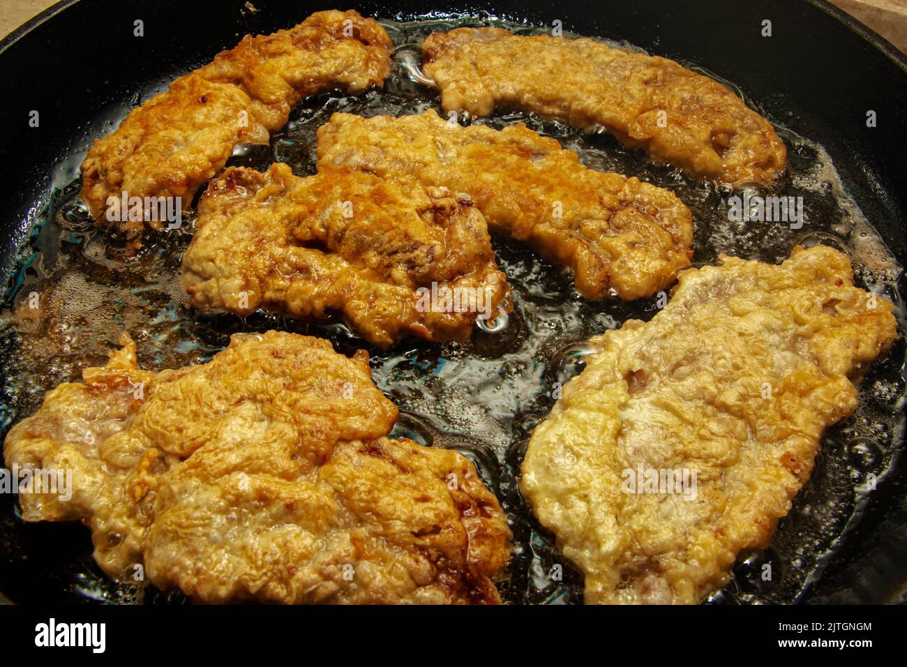 Beef chops in a pan on the stove. The process of preparing beef chops ...