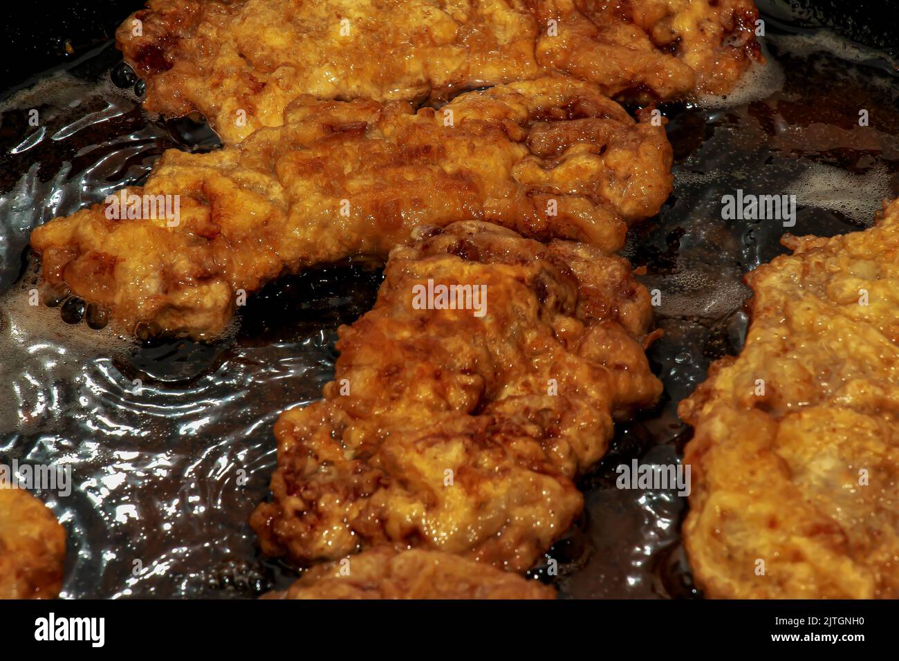 Beef chops in a pan on the stove. The process of preparing beef chops ...