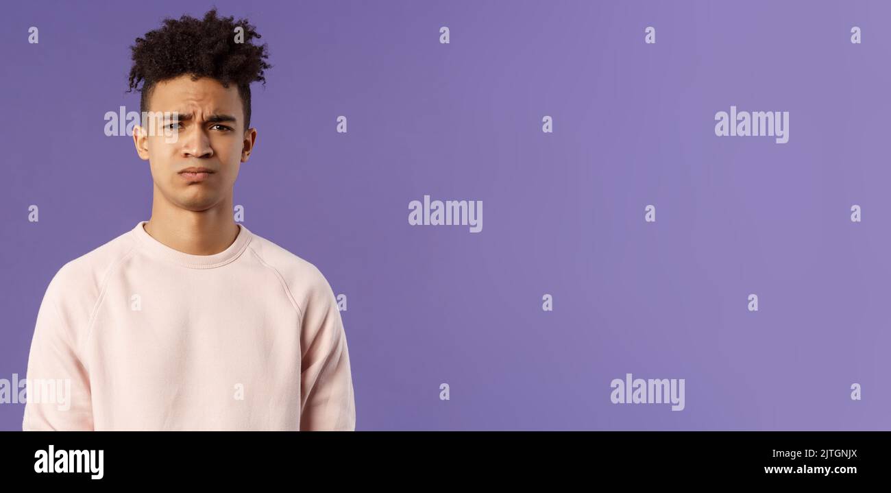 Close-up portrait of skeptical and gloomy, disappointed hispanic young ...