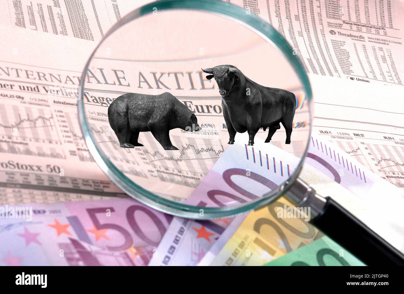 symbolic figures of the stock exchange, bull and bear standing on paper ...