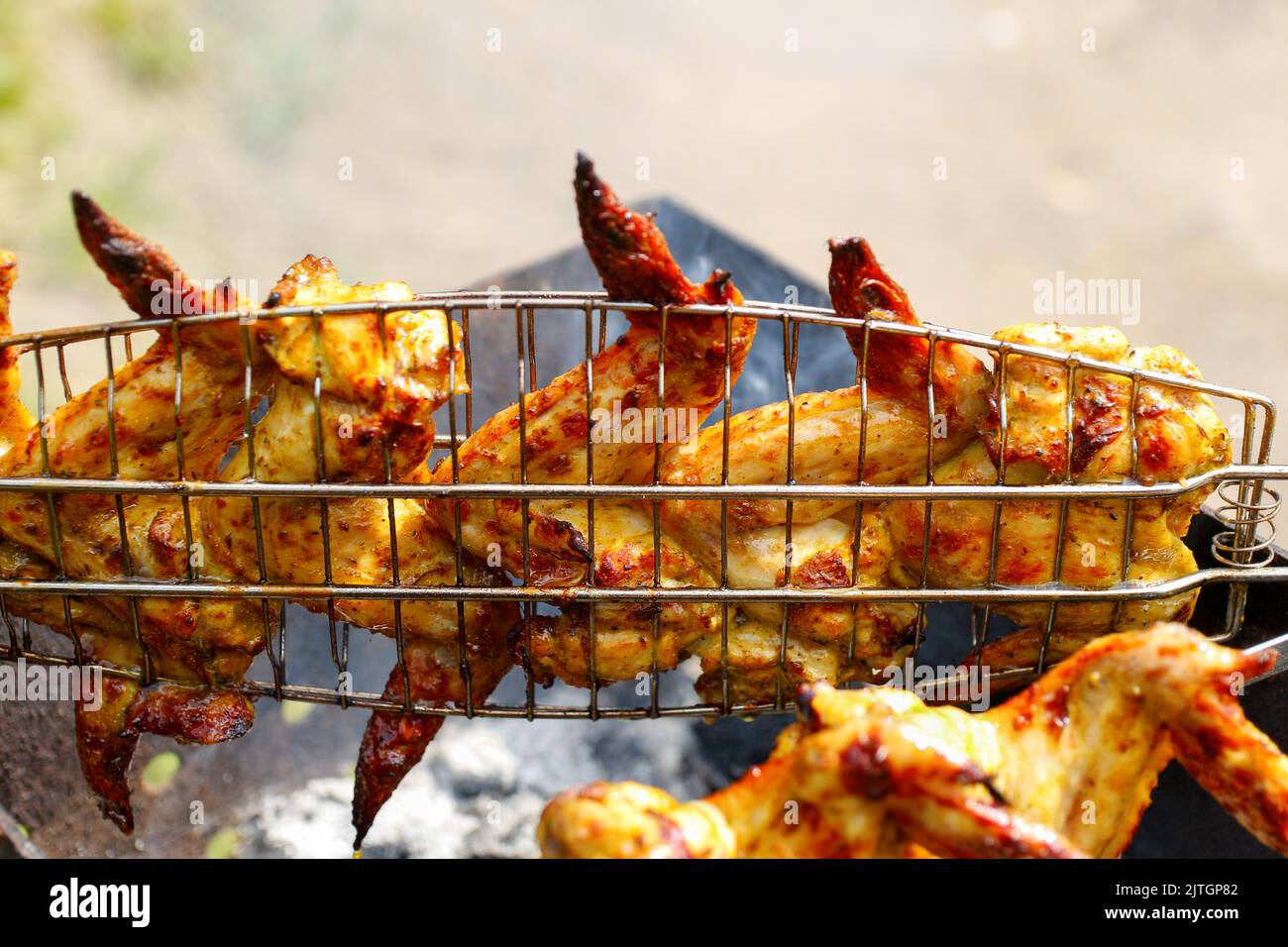 Defocus delicious chicken wings barbecue on hot grill. Chicken legs and ...